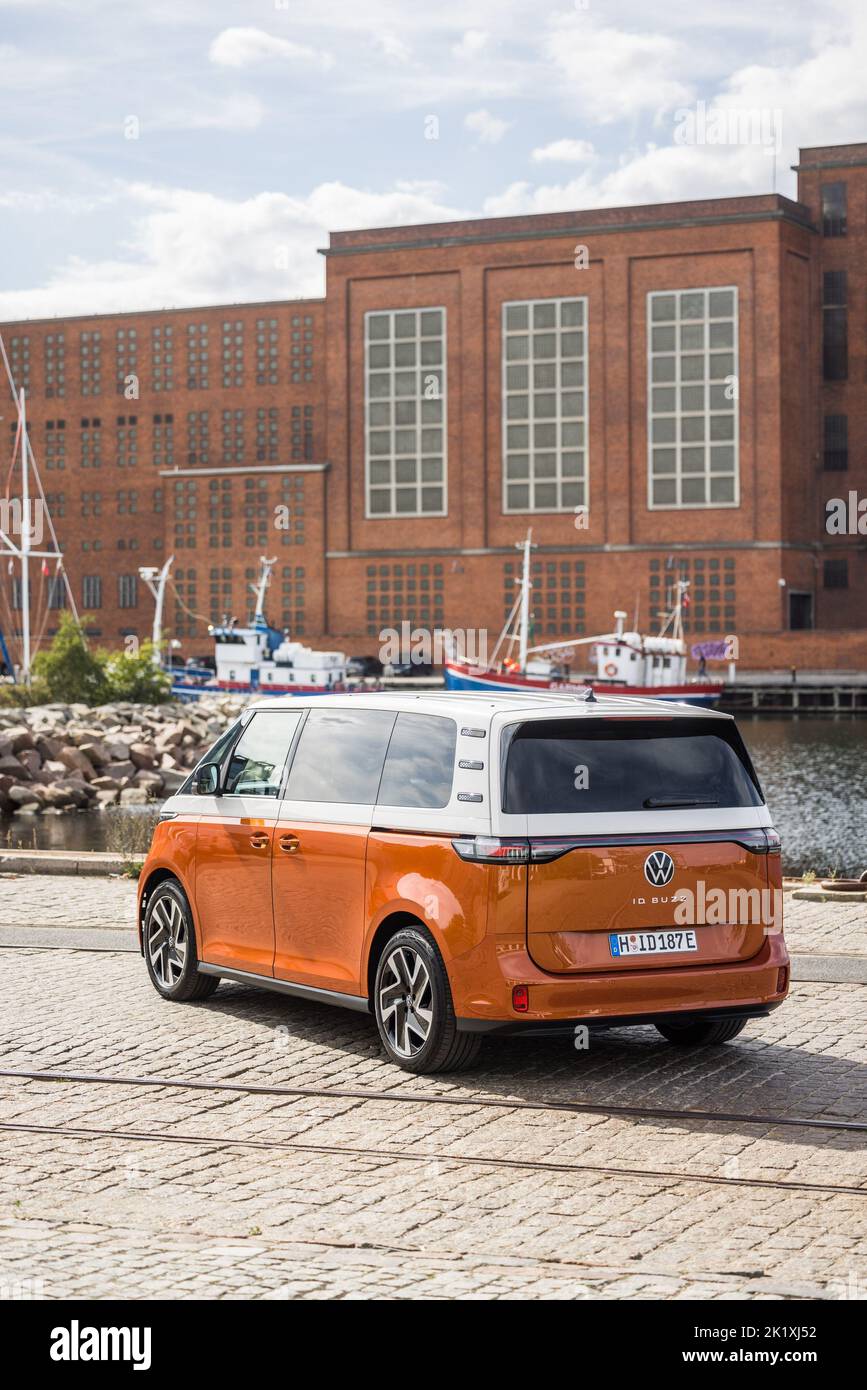 A vertical shot of the rear view of an orange Volkswagen ID. Buzz ...