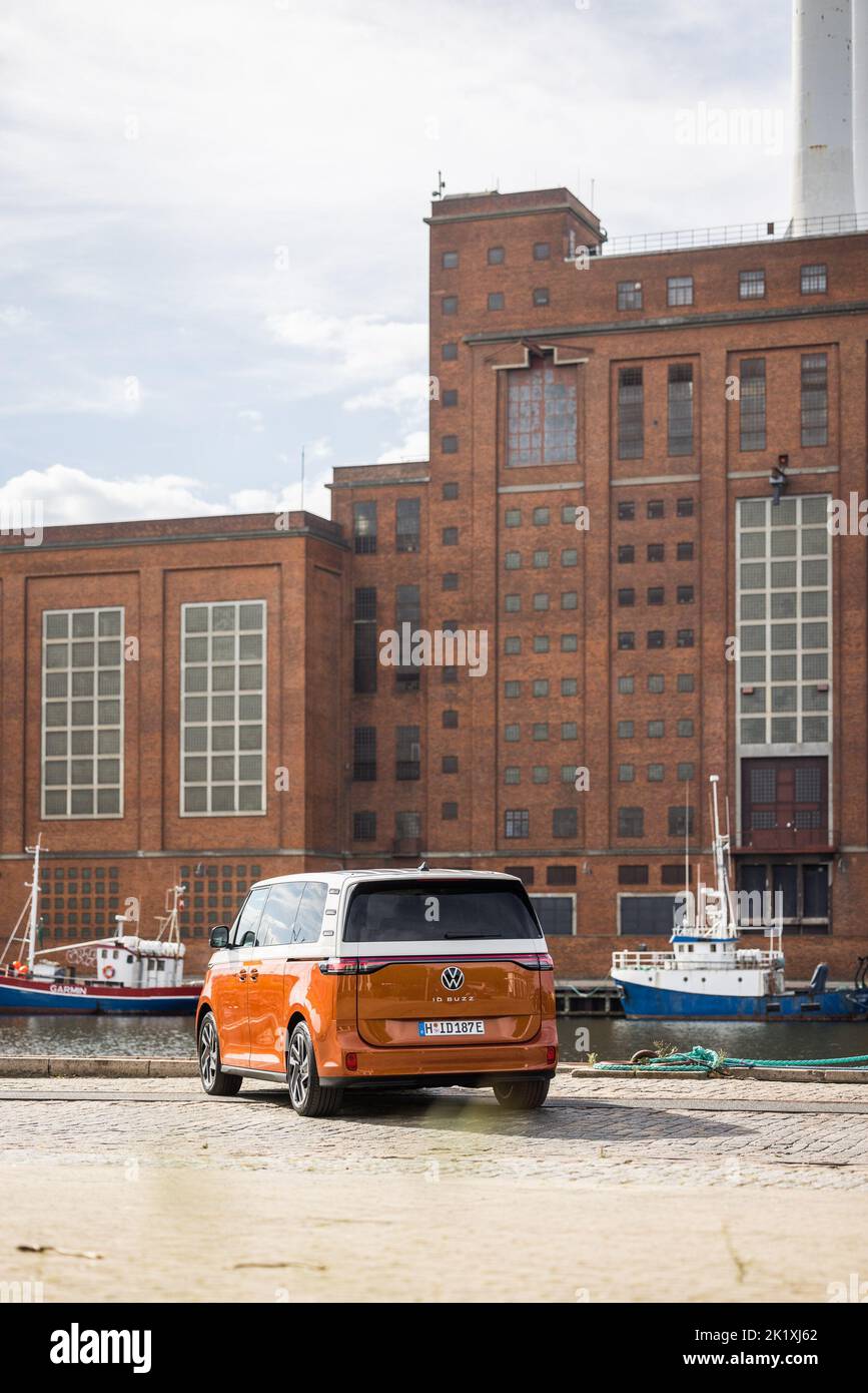 A vertical shot of the rear view of an orange Volkswagen ID. Buzz ...