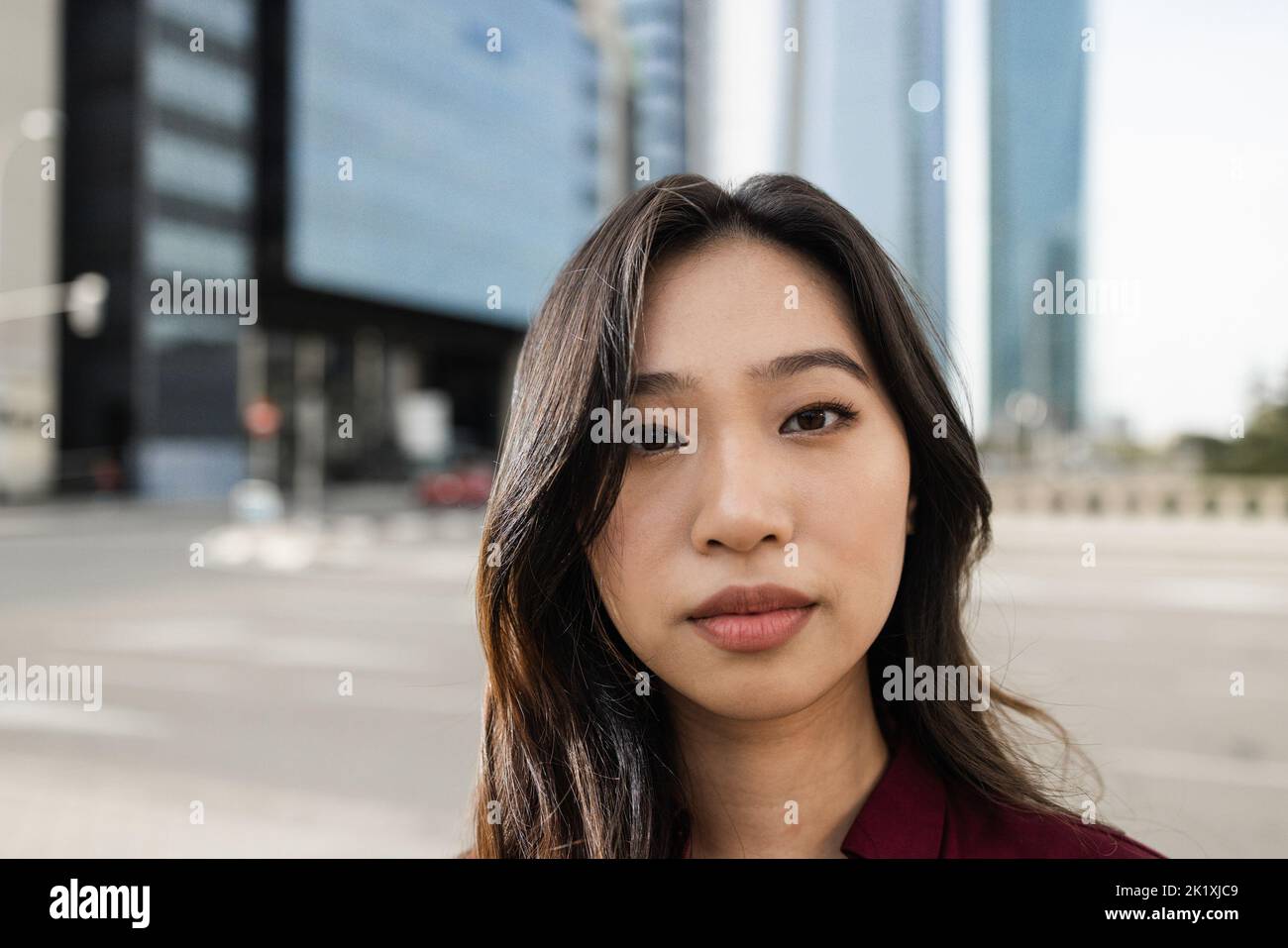Asian business woman working outside of the office with city in ...