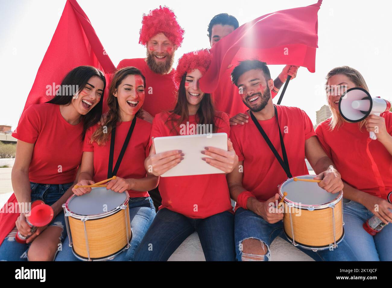 Crazy sport supporters watching football on tablet computer - Focus on ...