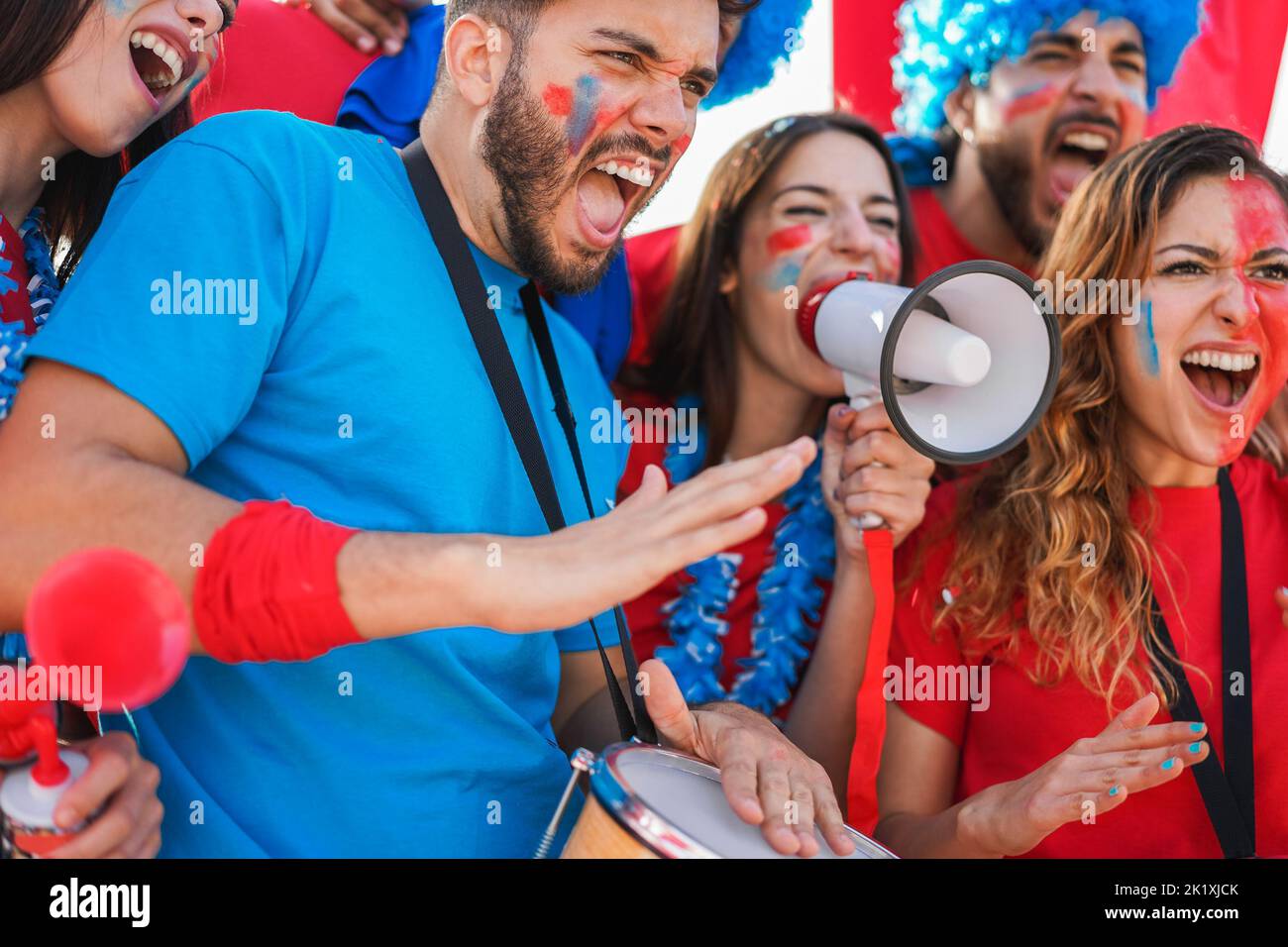 Crazy sport fans screaming while supporting their team - Focus on left ...