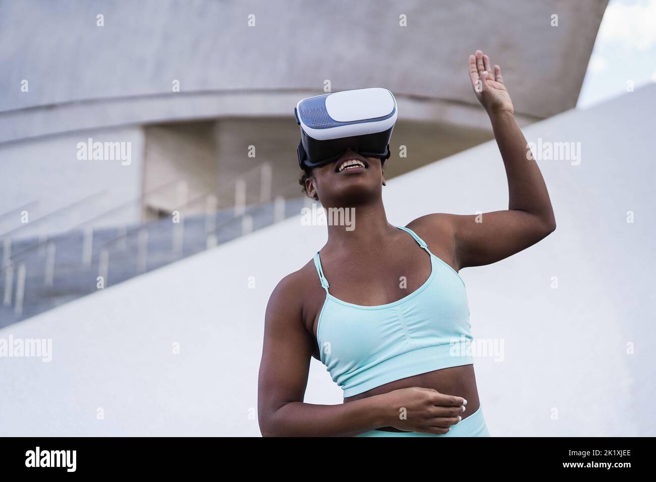 Fit african woman wearing virtual reality headset during workout ...