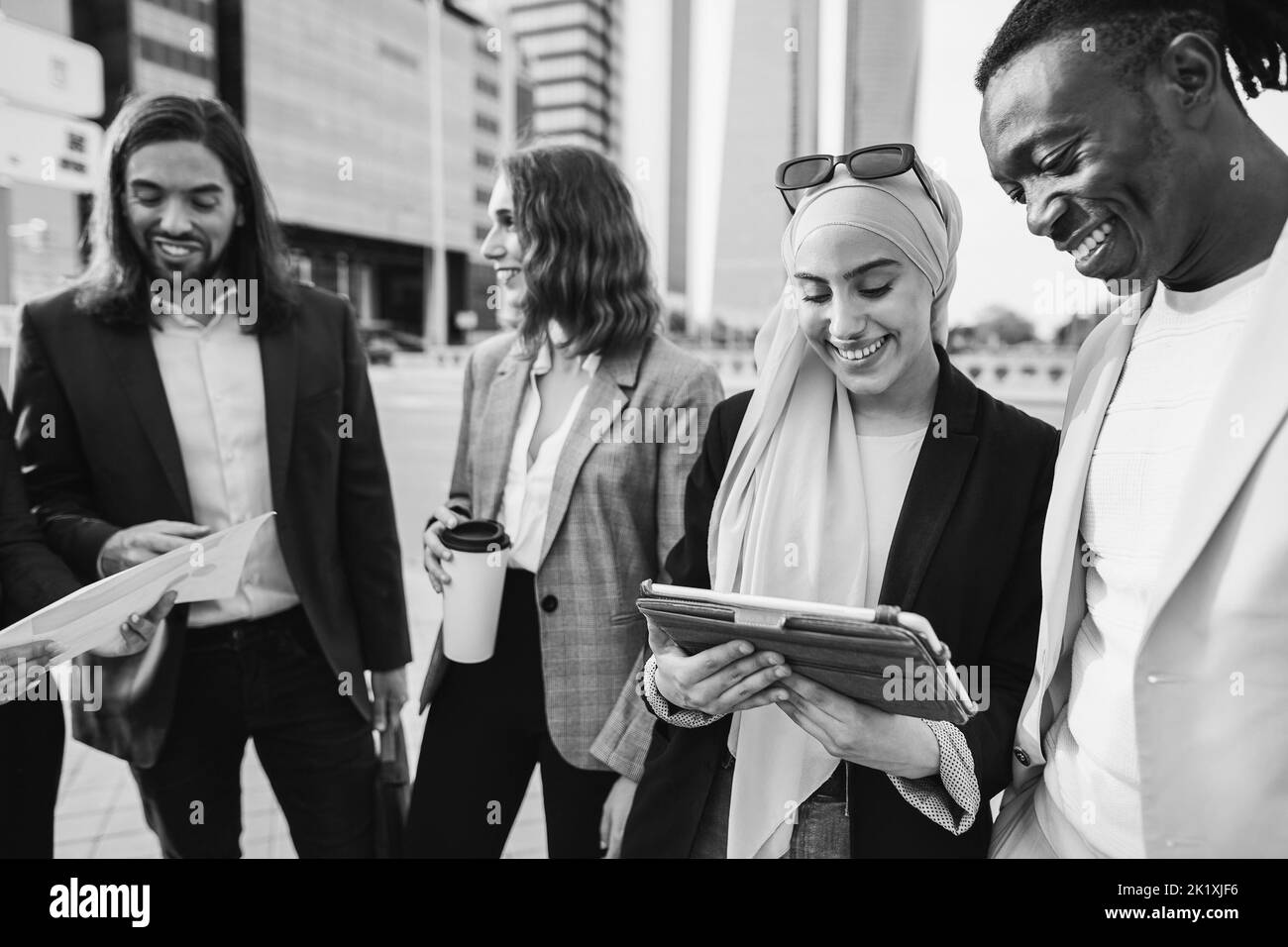Multiracial business people working outdoor from office building ...