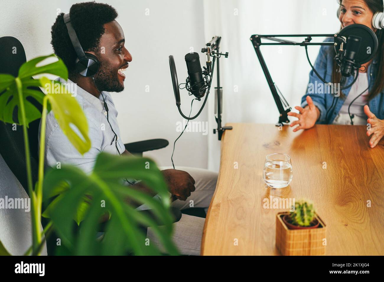 Multiracial hosts streaming podcast together at record studio - Focus ...