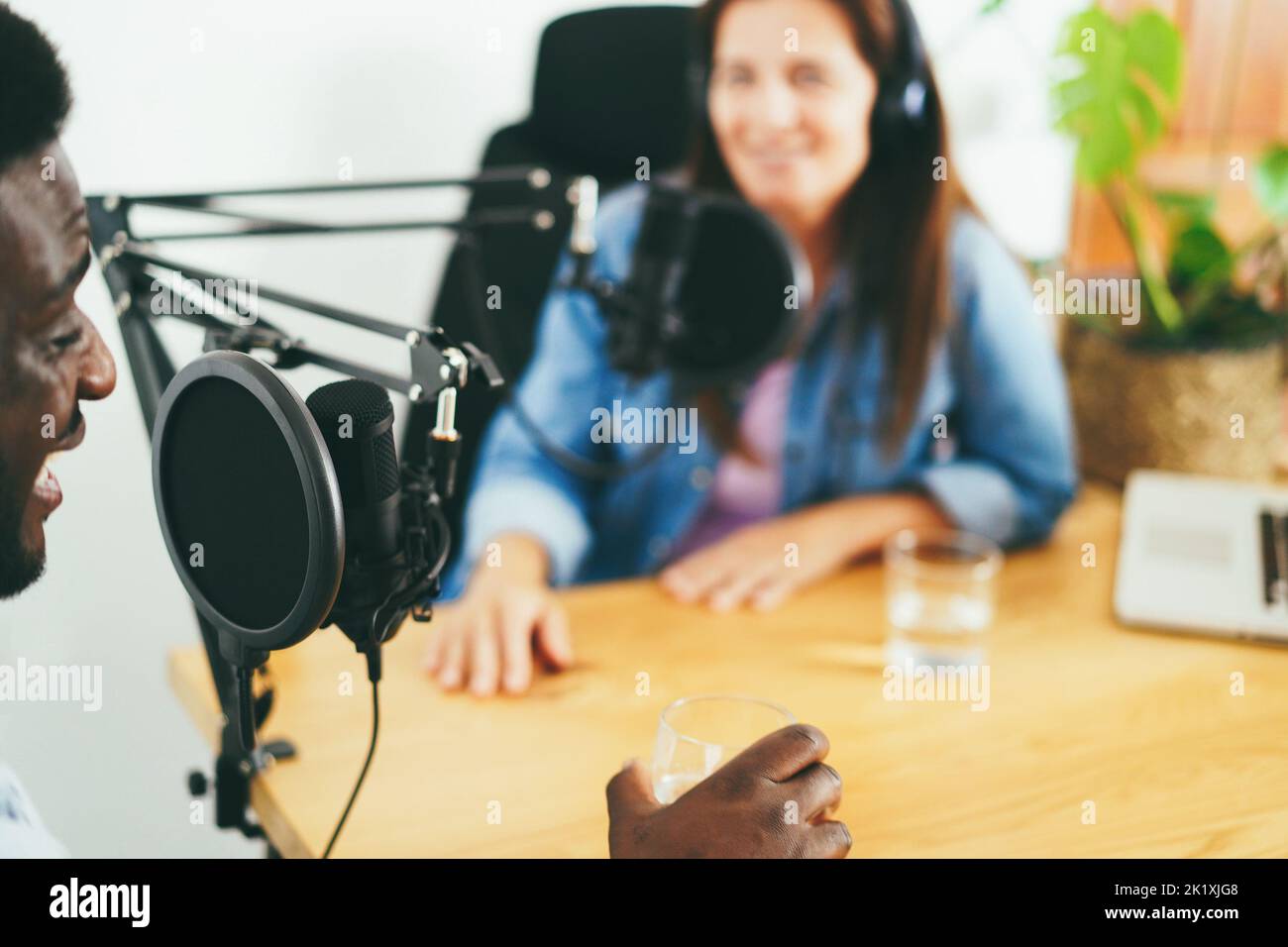Hosts having podcast session together - African speaker making an ...