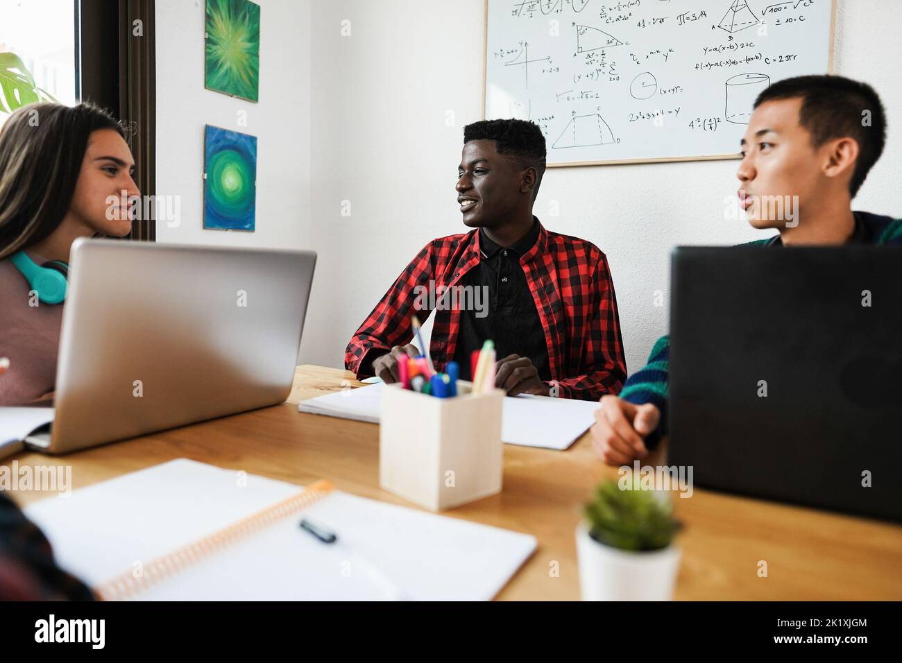 Multiracial students studying together at library - Focus on african ...
