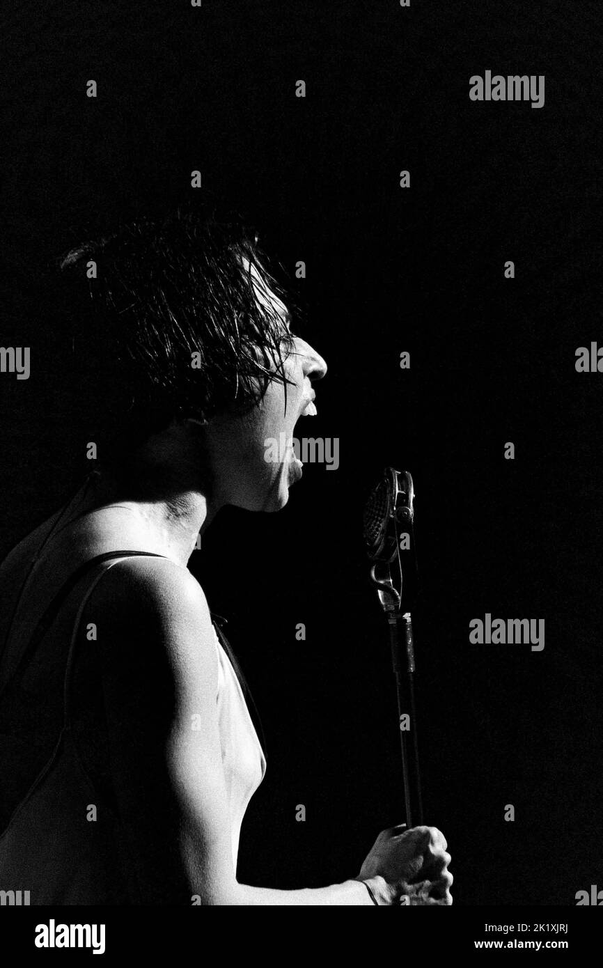 A grayscale shot of a person singing dramatically for a musical play ...