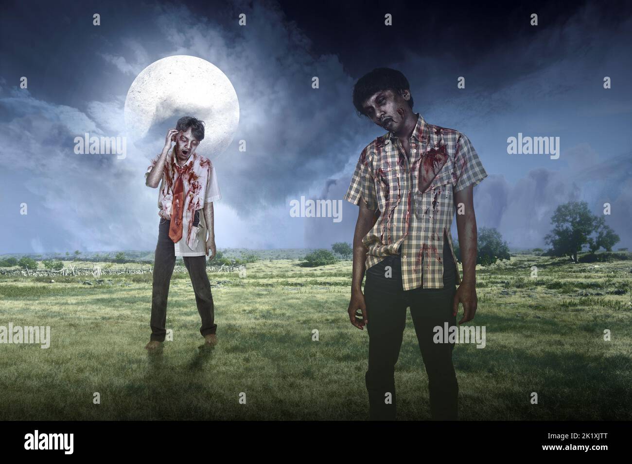 Scary zombie with blood and wound on his body walking on the field ...