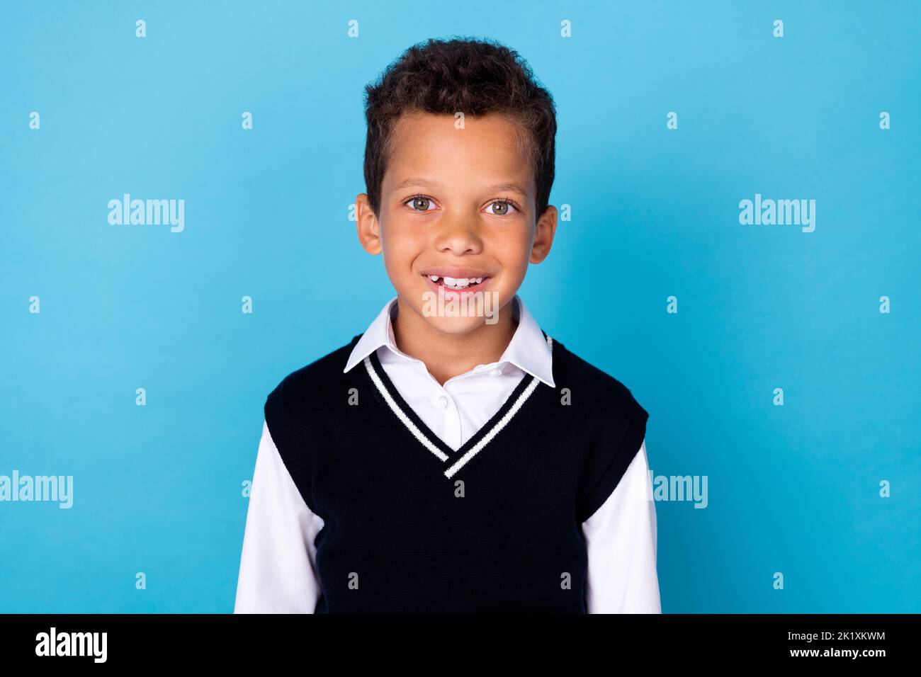 Photo of cheerful positive small boy wear black waistcoat smiling ...