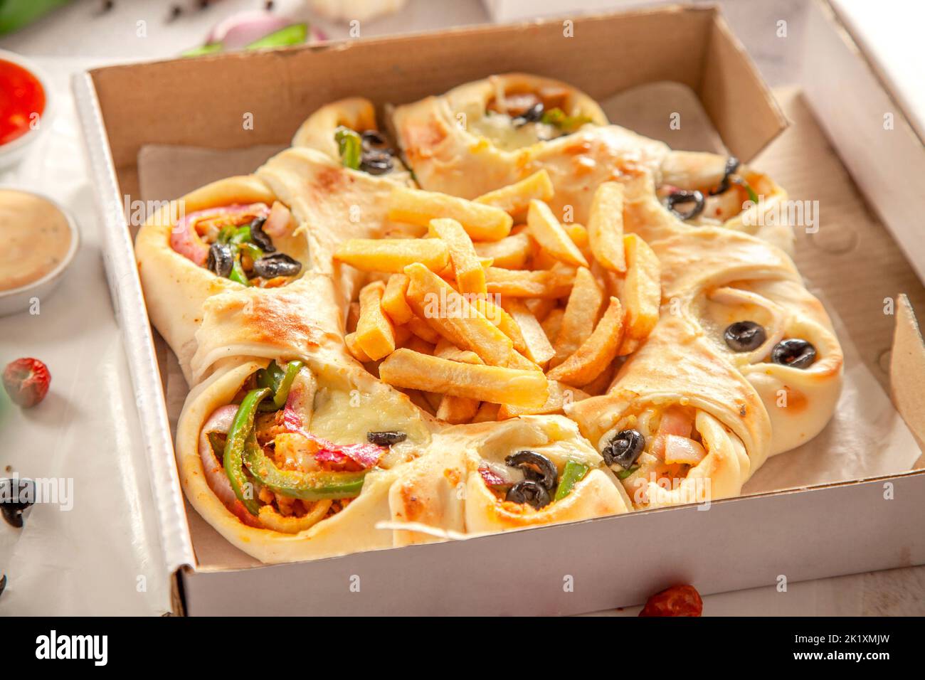 Chicken fajita stuffed bread naan with potato chips fries in a delivery ...