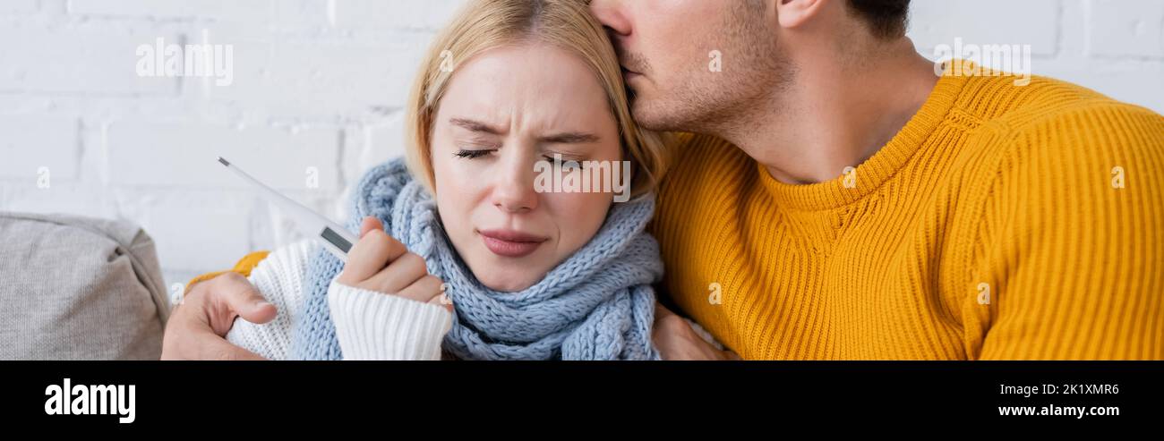 man hugging and kissing head of sick blonde woman with digital ...