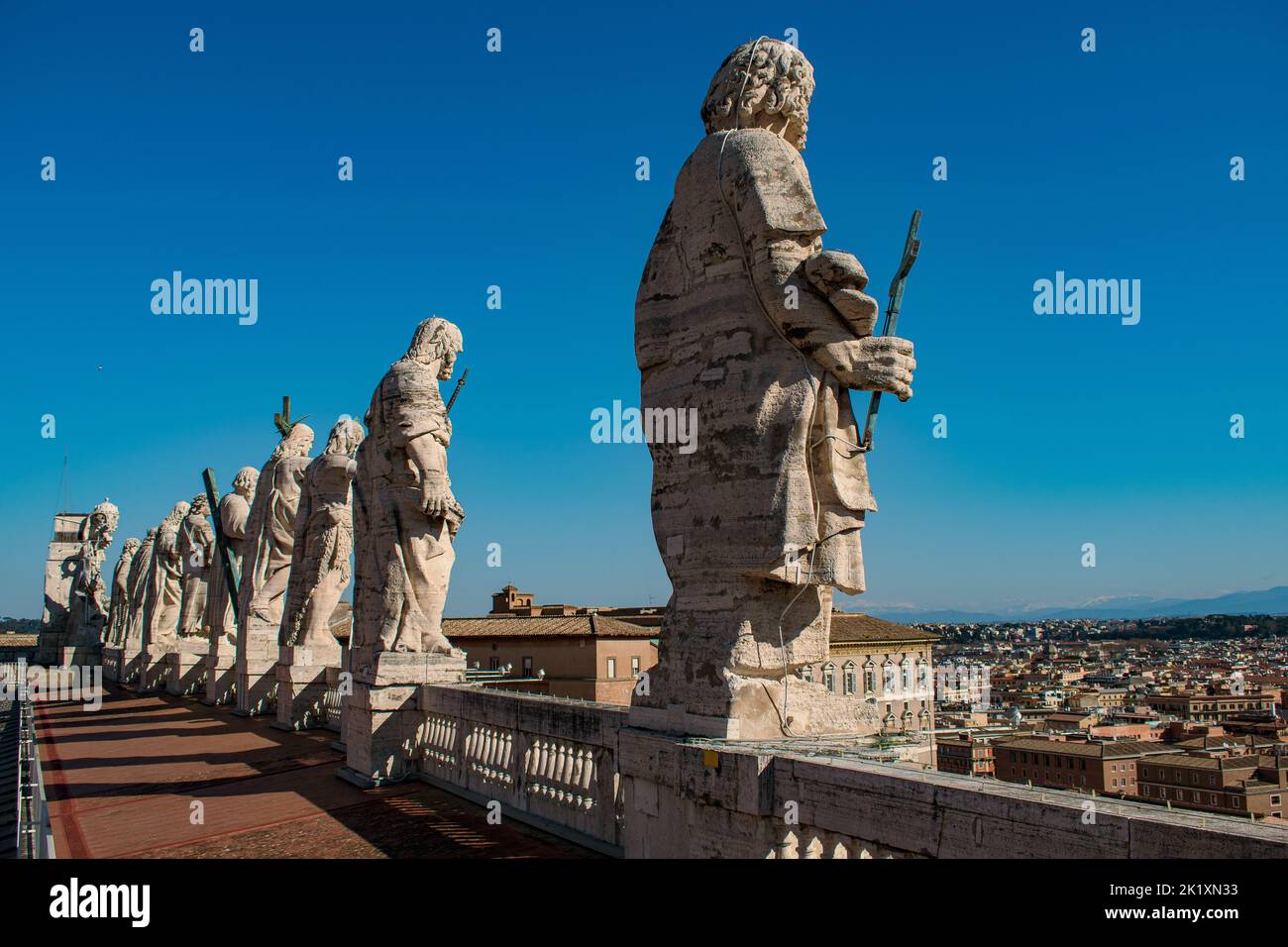 A view of statues in St. Peter's Square surrounded by buildings Stock ...