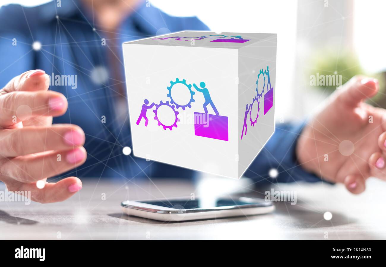 Smartphone with teamwork concept between hands of a woman in background ...