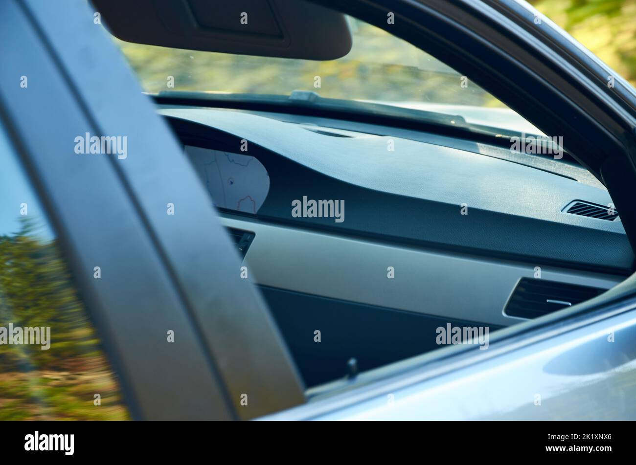 Part of a front car interior through an open window Stock Photo - Alamy