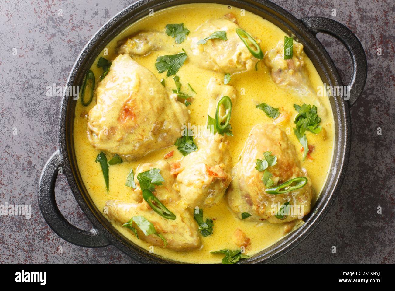 African chicken in coconut curry sauce closeup in the pan on the table ...