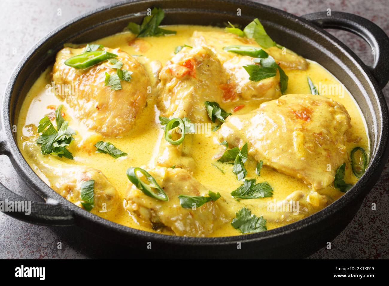 African food chicken stew in coconut sauce with spices, tomato, garlic ...