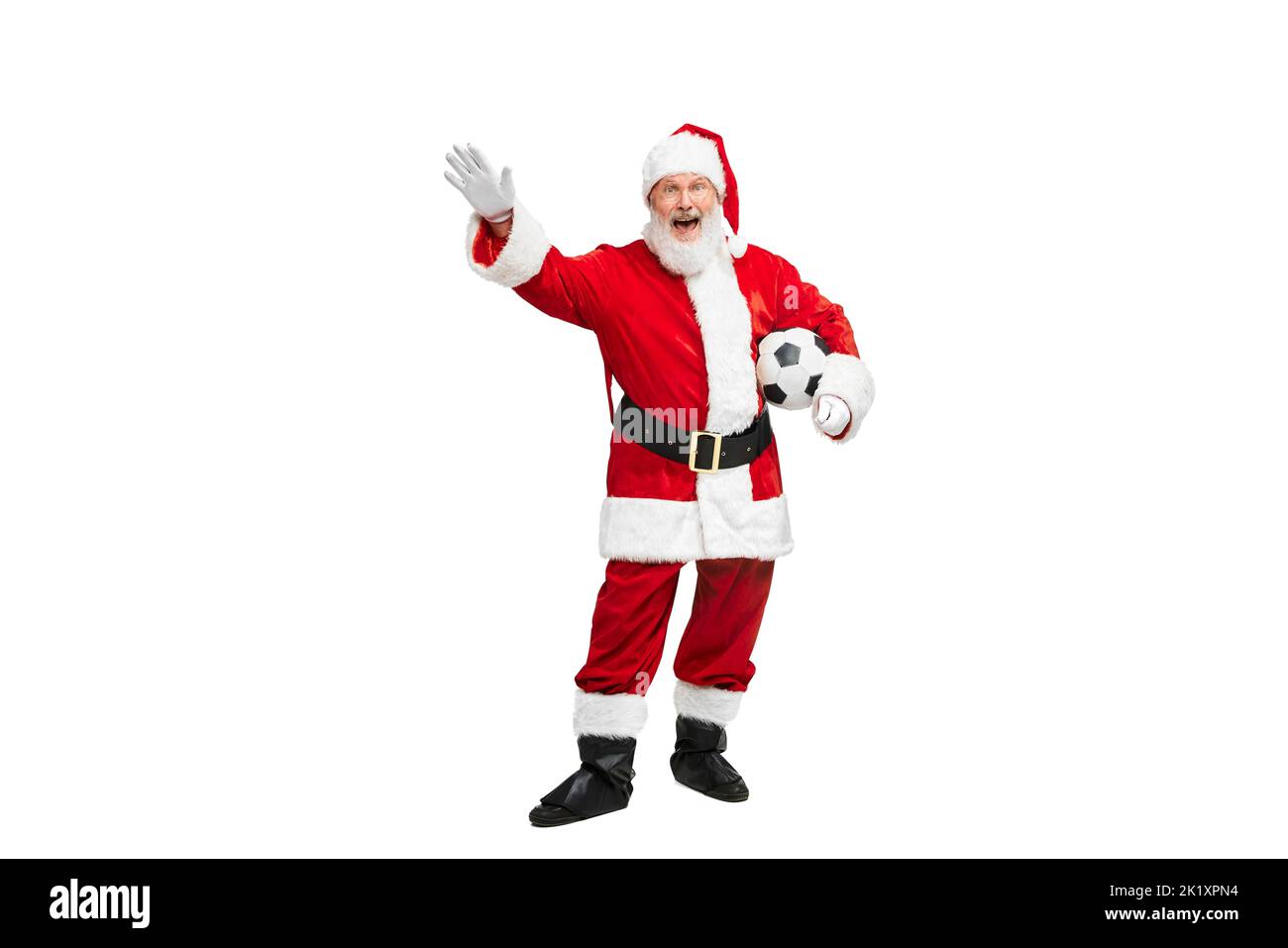 Portrait of senior man in image of Santa Claus posing with football ...