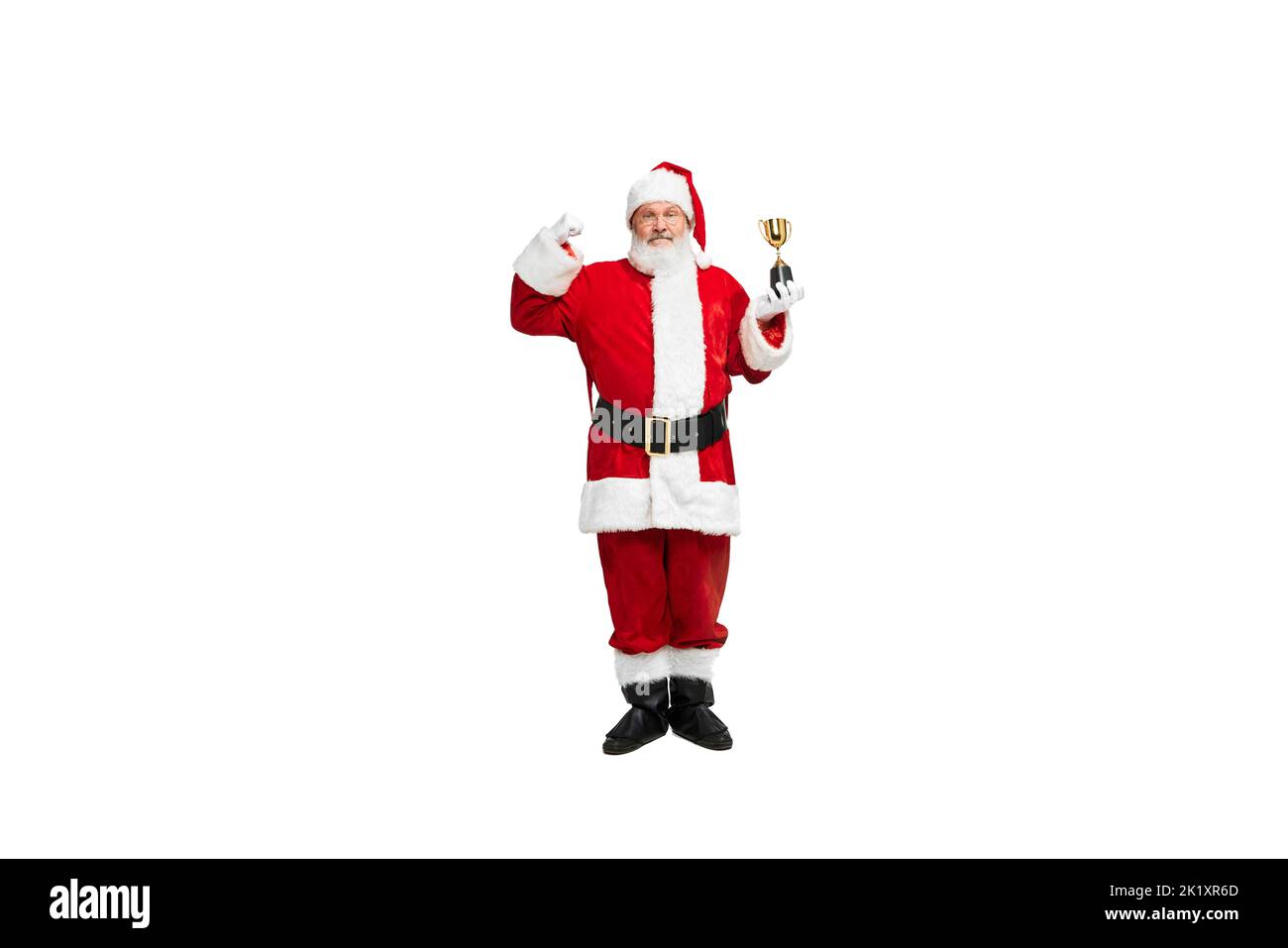 Portrait of senior man in image of Santa Claus standing with winning ...