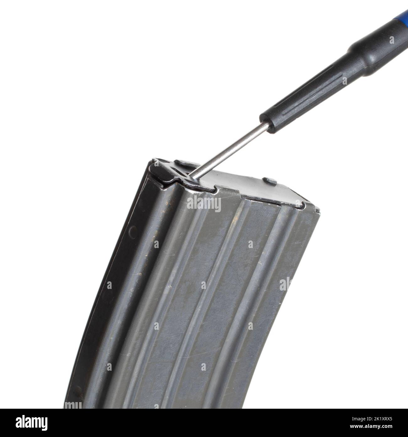 Screwdriver prying up the bottom of an AR-15 magazine isolated on white ...