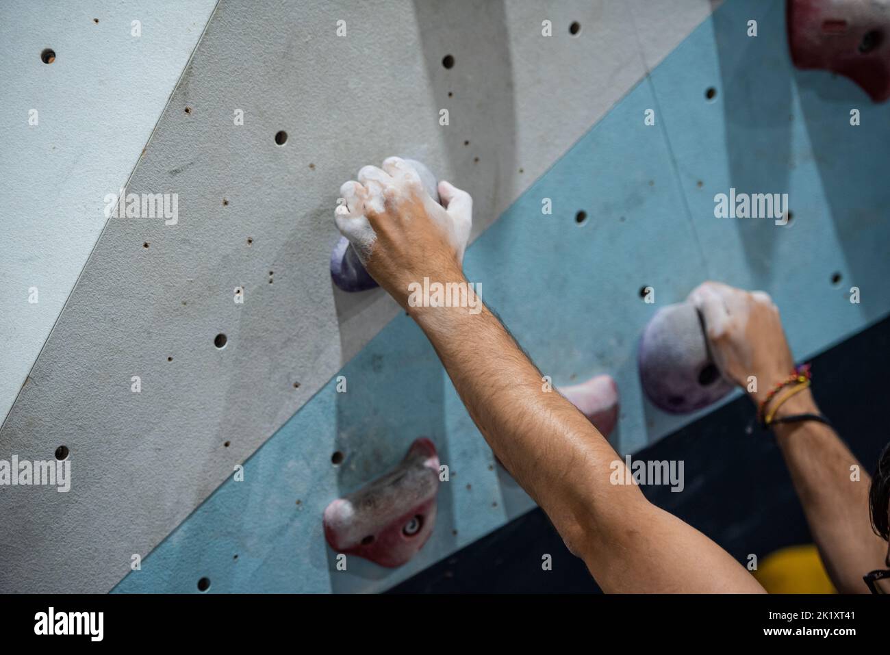 Hand reaching a climbing hold on a climbing wall Stock Photo - Alamy