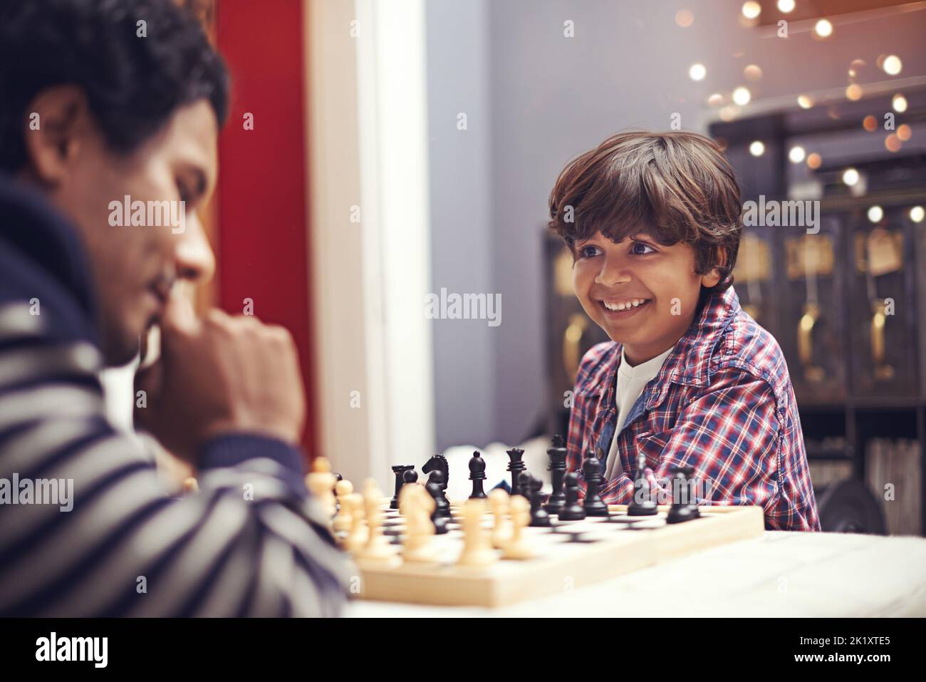 Whats your move, Dad. a father and son playing a game of chess at home ...