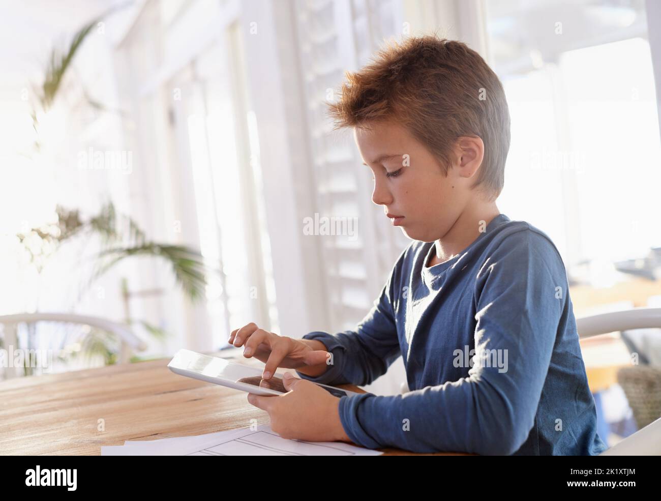 This makes learning so much better. a young boy using a digital tablet ...
