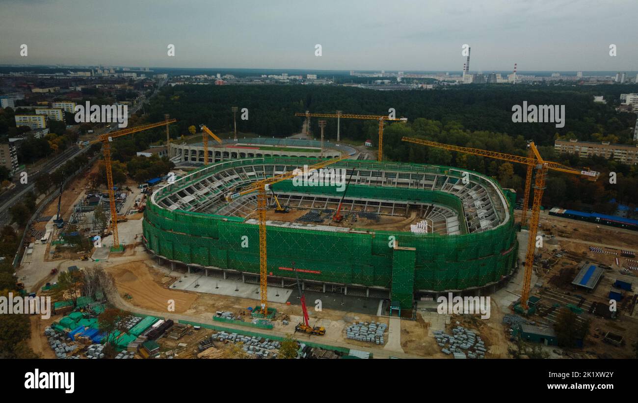 Building a stadium in a big city. Construction site among urban areas ...