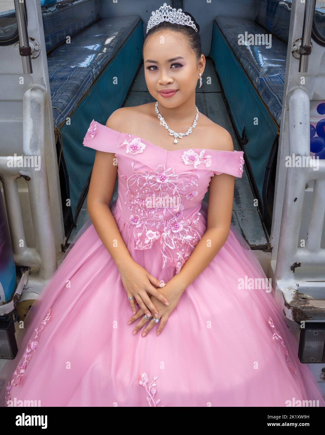 A philippine princess wearing a pink dress and a crown and looking at ...
