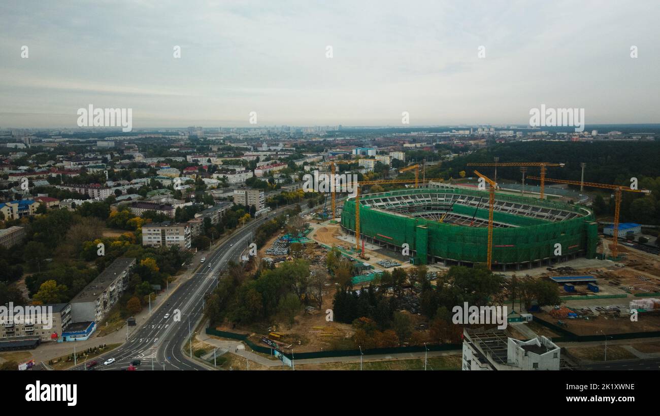 Building a stadium in a big city. Construction site among urban areas ...