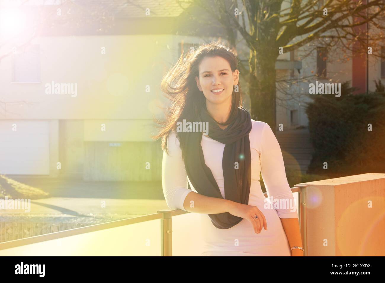 Happy and beautiful. Portrait of an attractive woman standing outside ...