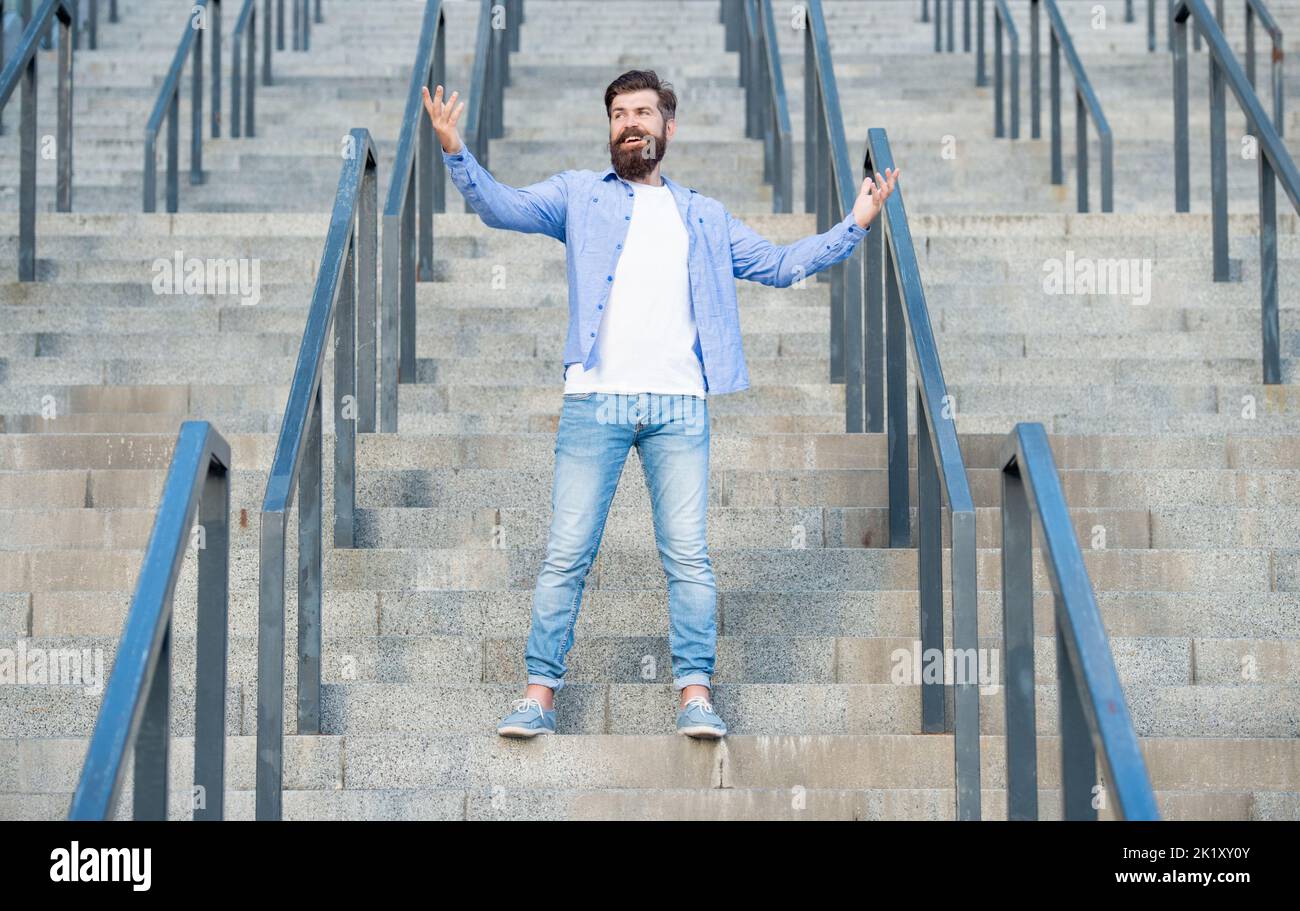 smiling hipster downstairs. full length of hipster with beard. hipster ...