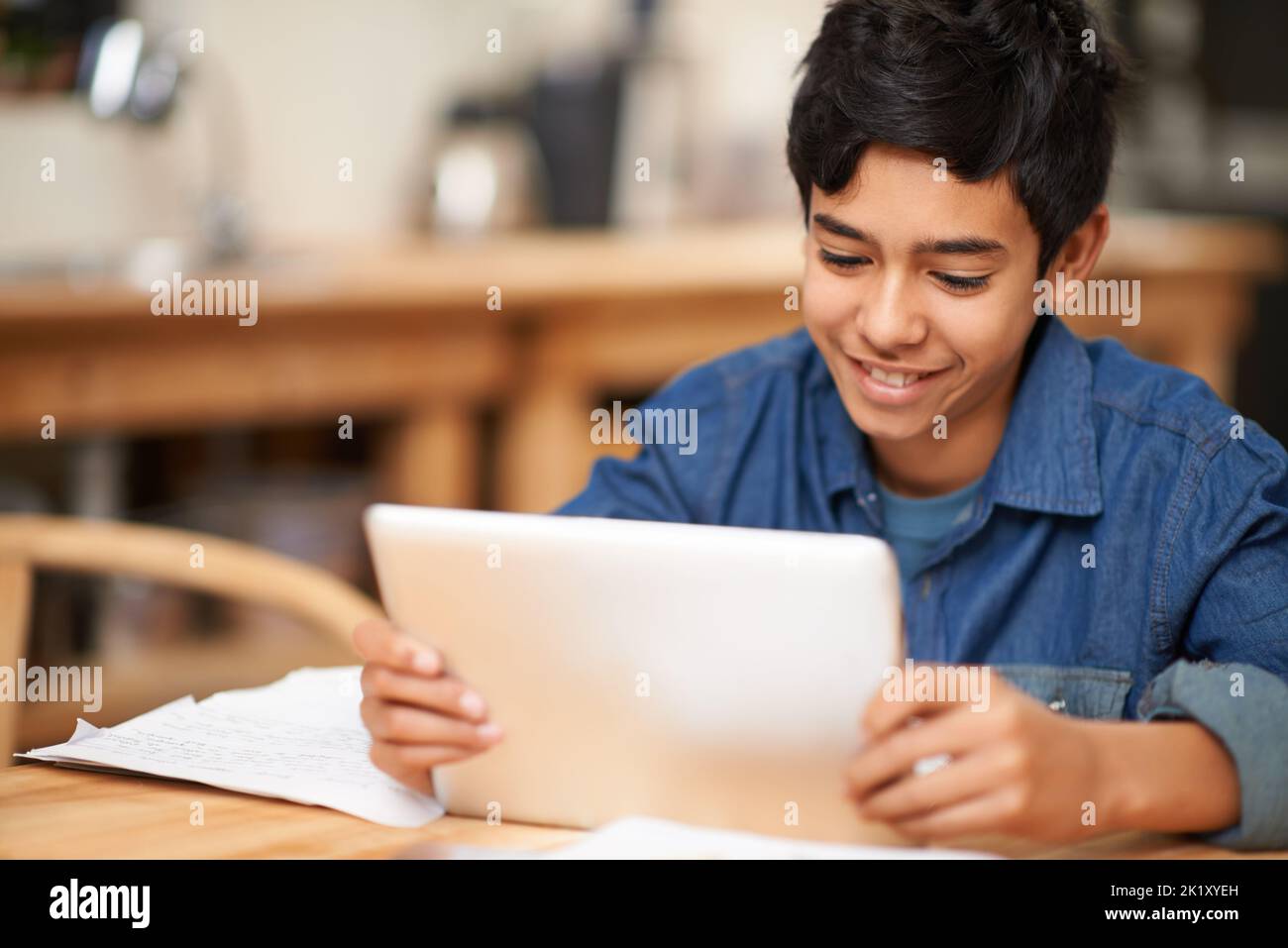 Getting my learn-on digitally. a young teenage boy using a digital ...