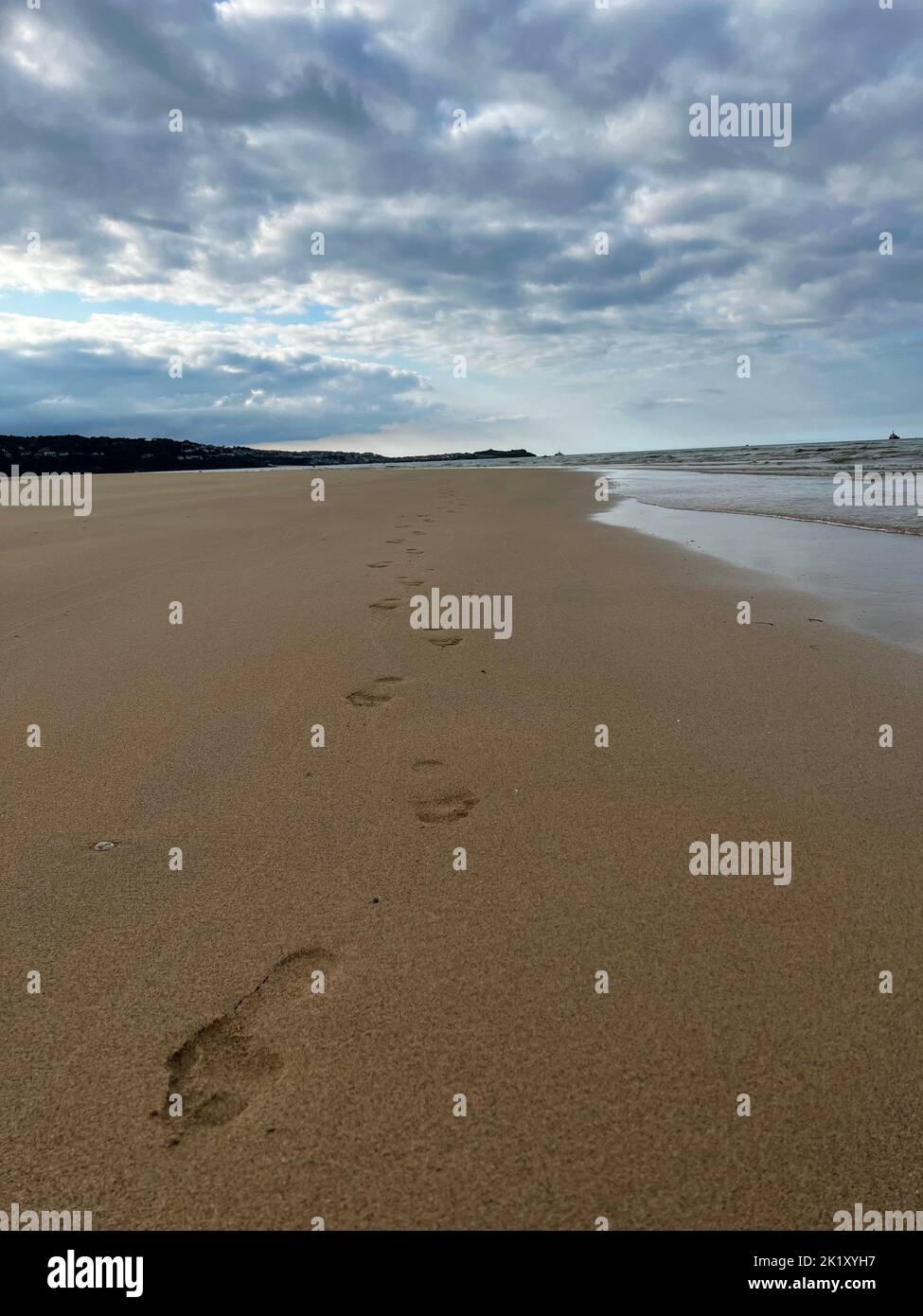 Footprints in the sand on a beach Stock Photo - Alamy