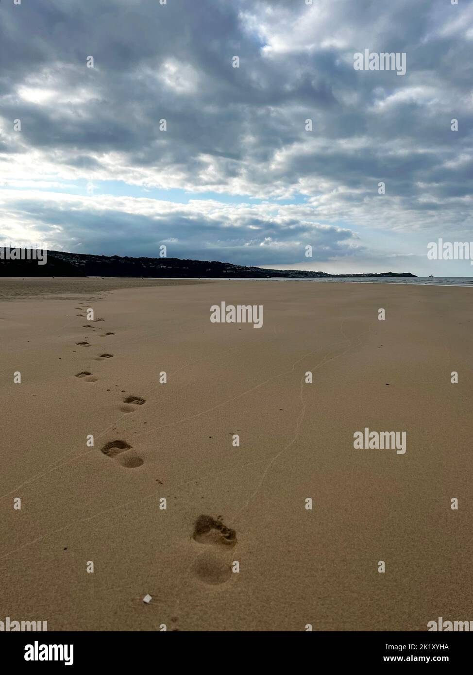 Footprints in the sand on a beach Stock Photo - Alamy