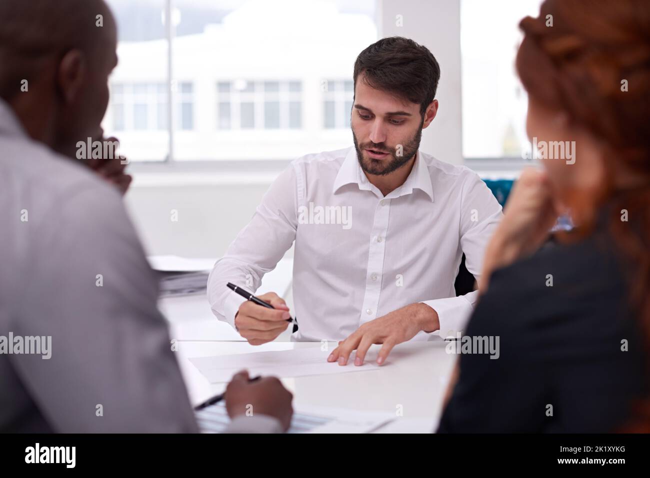 Getting down to business. a diverse group of young businesspeople ...