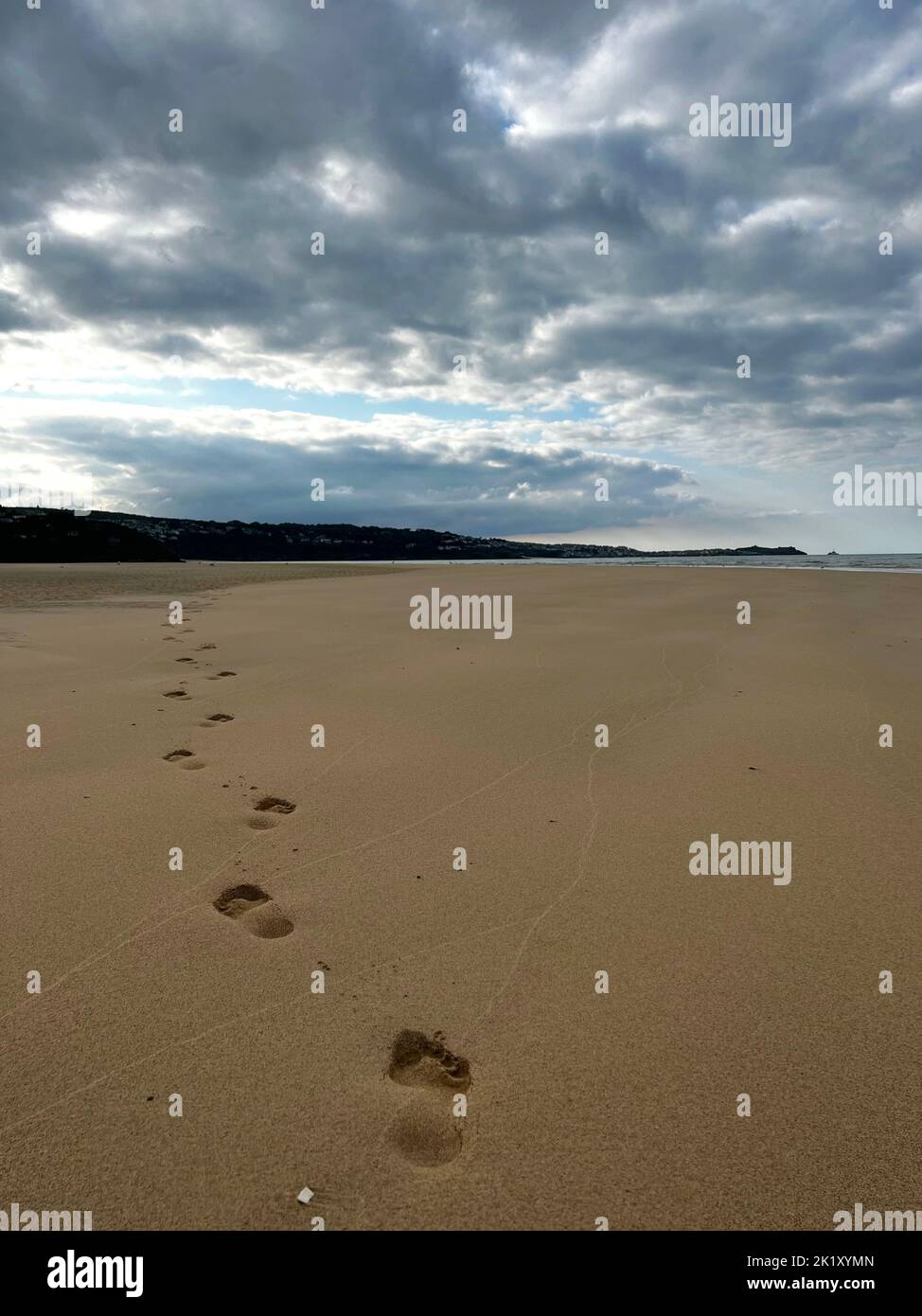 Footprints in the sand on a beach Stock Photo - Alamy