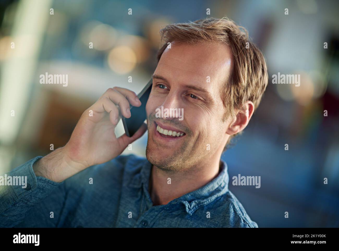 Client calls. a handsome businessman talking on his mobile phone in the ...