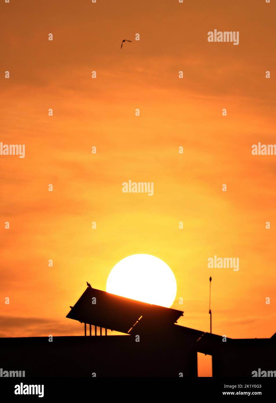 The Sun rising over solar panel on rooftop/Ahmedabad Stock Photo - Alamy