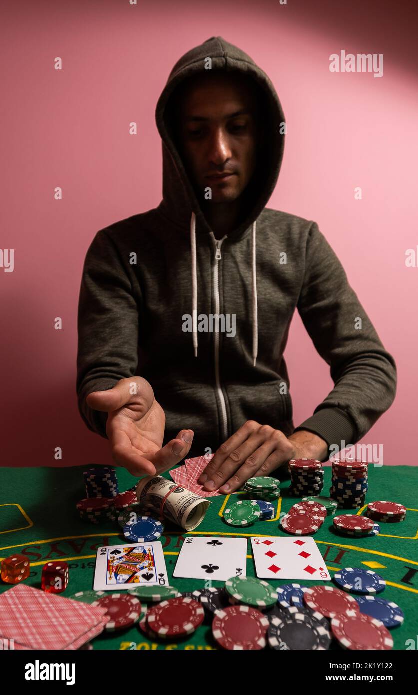 Devastated gambler man losing a lot of money playing poker in casino ...