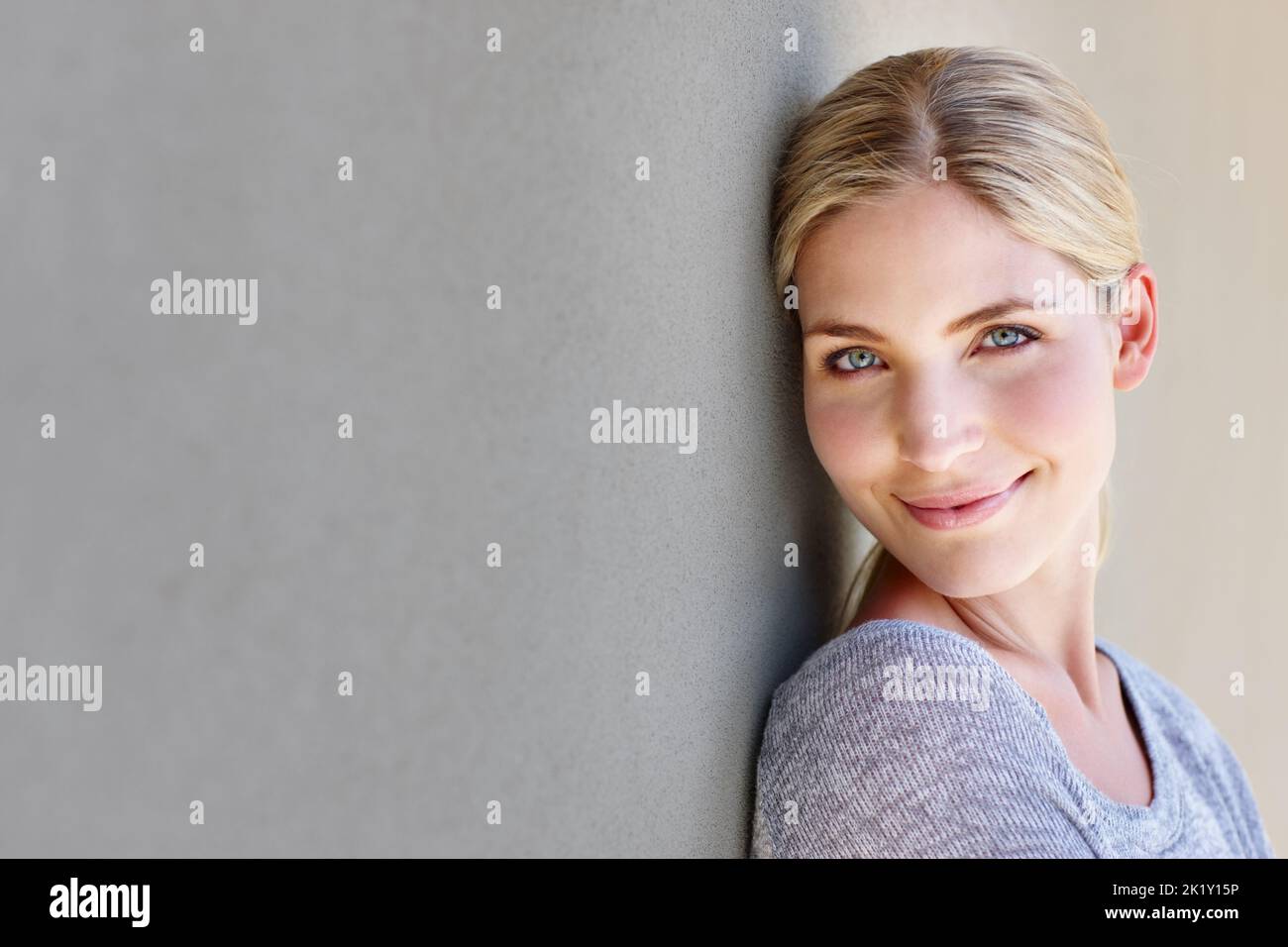 Life is simply beautiful. Portrait of a happy young woman leaning ...