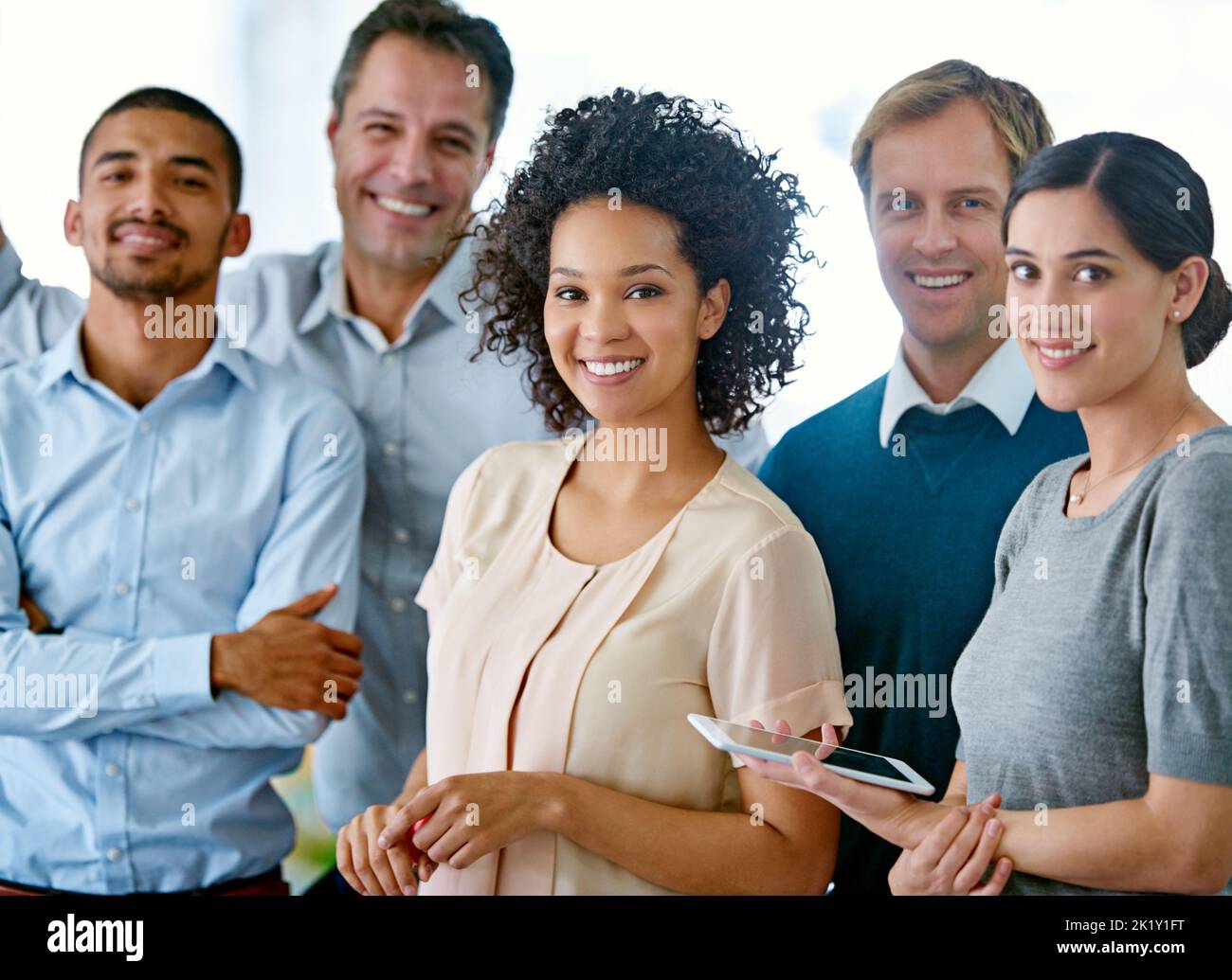 Synergy in practice. Portrait of a group of smiling coworkers standing ...