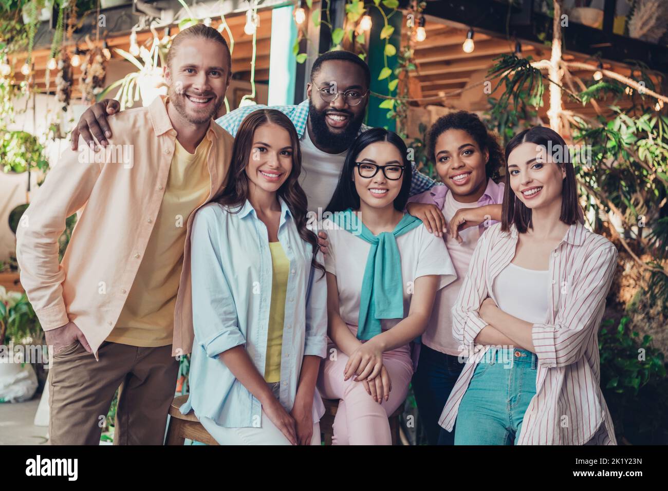 Portrait of cheerful satisfied group students hug embrace toothy smile ...