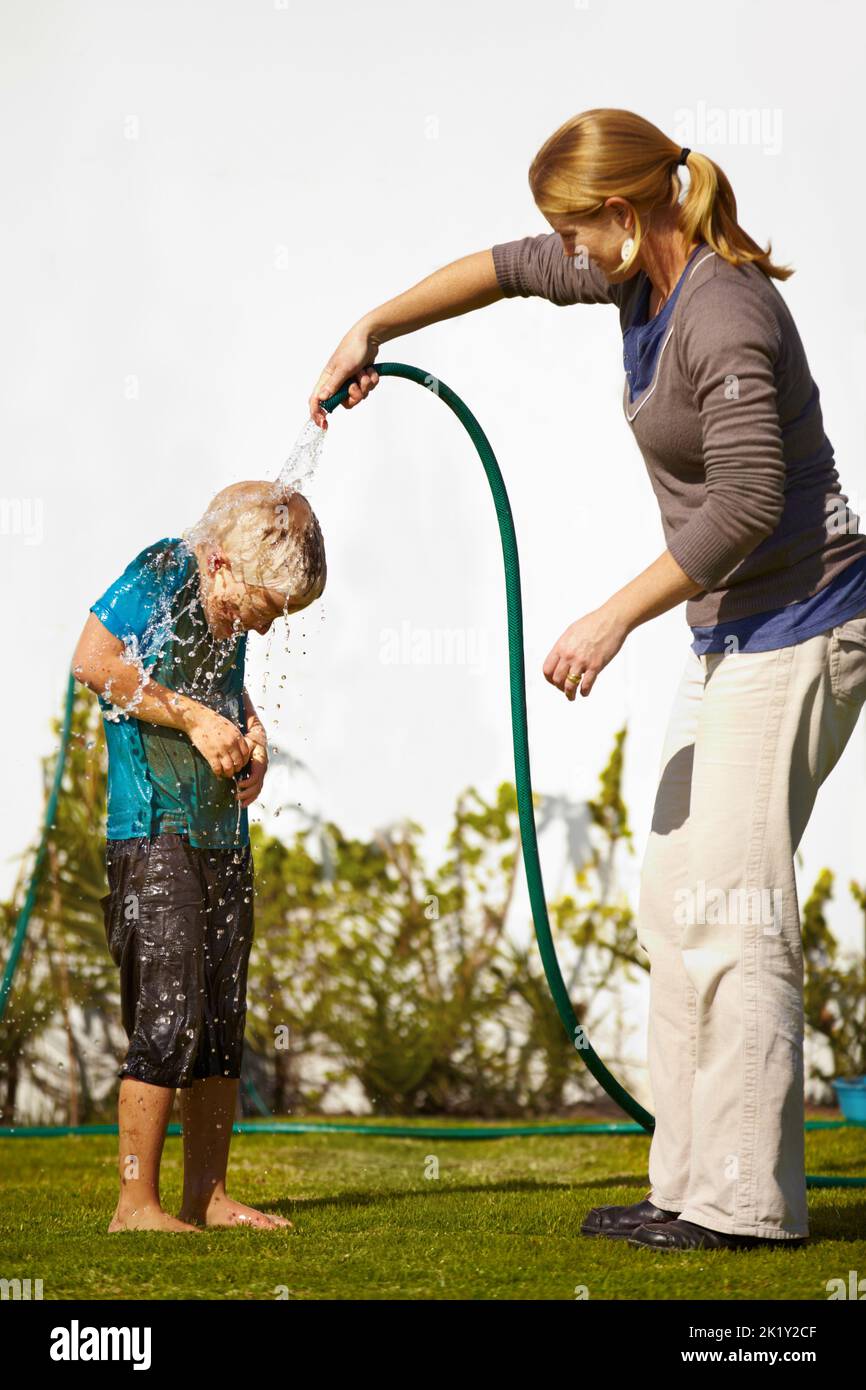 Time to clean off some of that dirt....Little boy getting wet by his ...