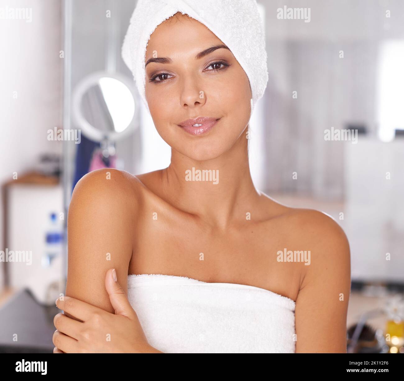 Now to get dressed. Portrait of a beautiful young woman standing in the ...