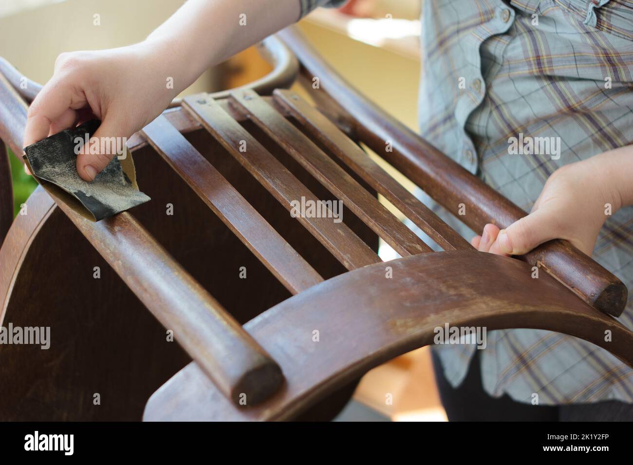 Chair repair with abrasive paper, preparing its for coloring Stock ...