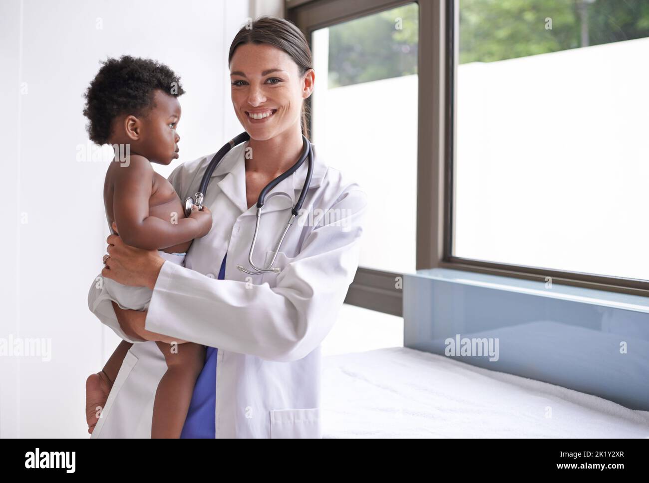 Just in for a routine pediatric checkup. a female pediatrician doing a ...