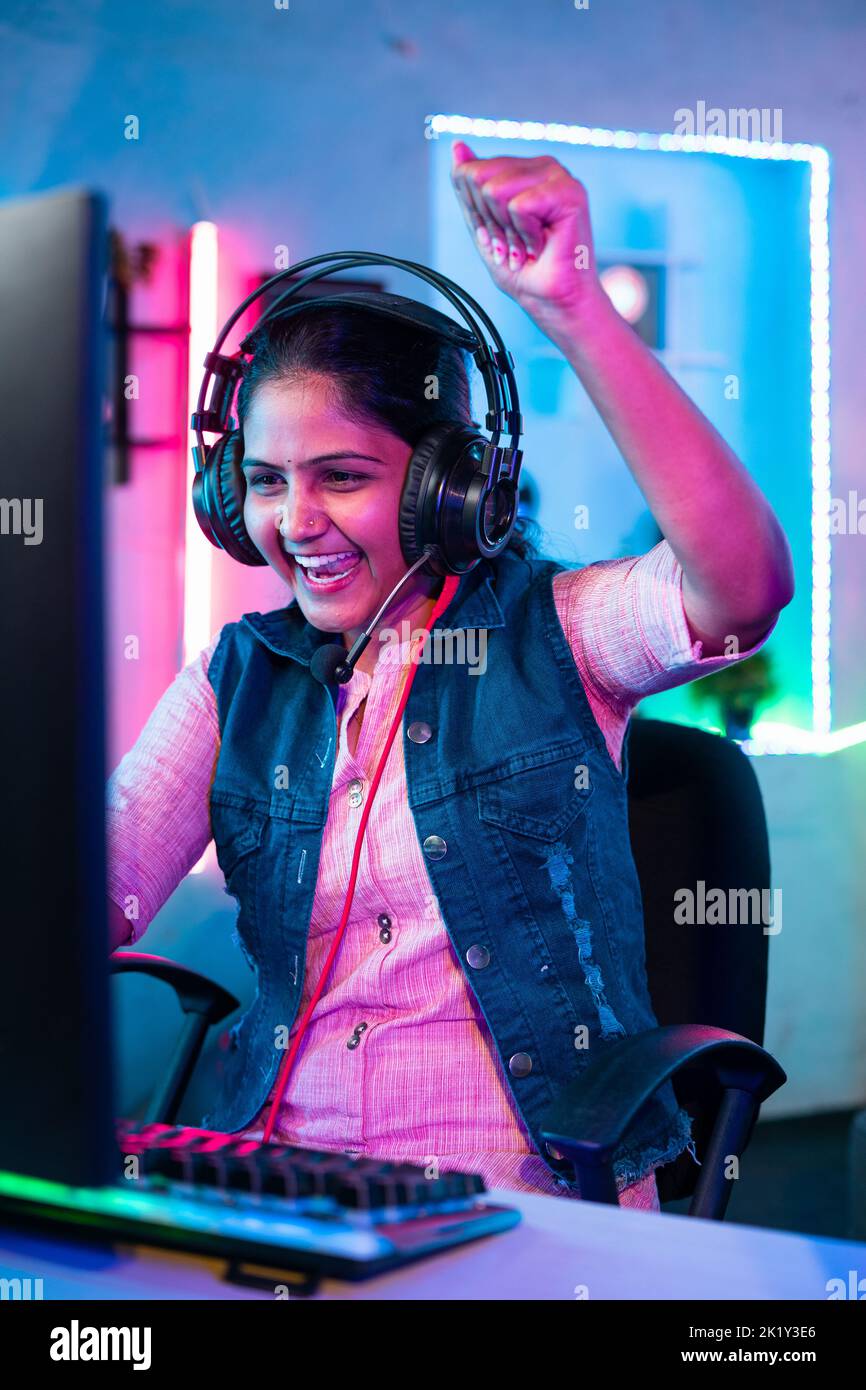 vertuical shot of happy gamer celebrating win or victory while playing ...