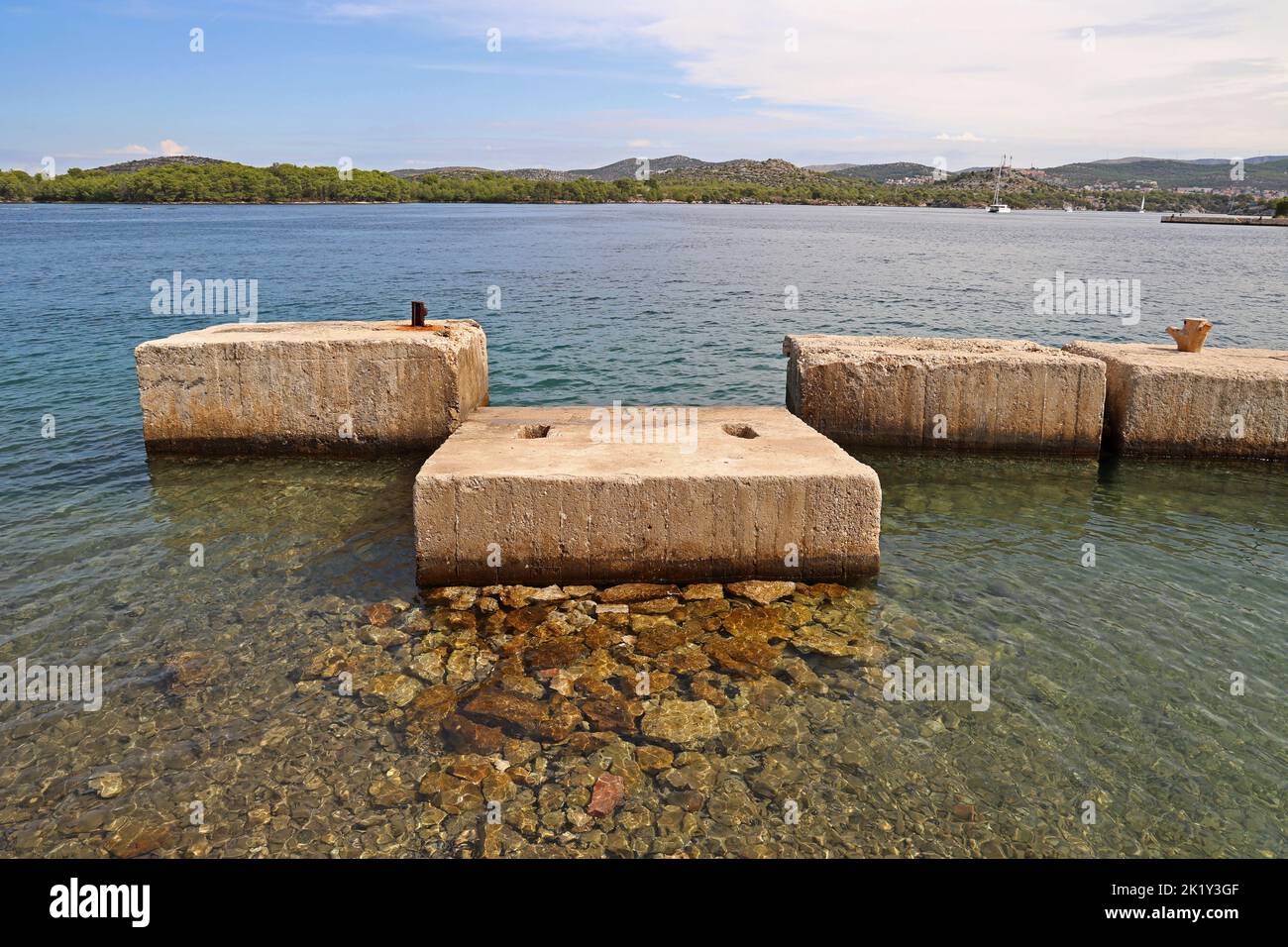 Large concrete blocks in the sea off the coast Stock Photo - Alamy