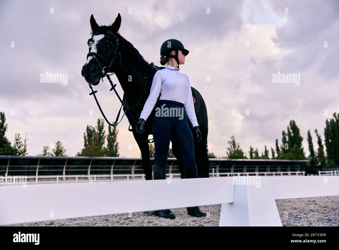 Young sportive girl, professional jockey or horsewoman in sports ...