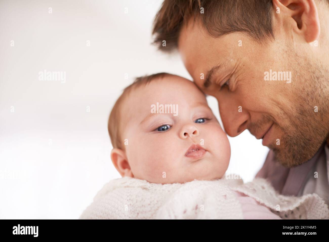 Hes one proud daddy. a young father holding his adorable baby daughter ...